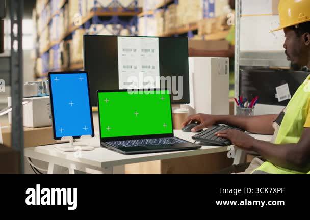Huge distribution center worker verifying parcel details with isolated ...