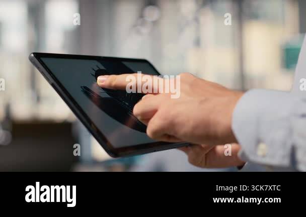 Close up of researcher analyzing turbine component on tablet to ...
