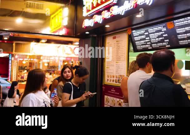 People waiting in line at a food stall Stock Video Footage - Alamy