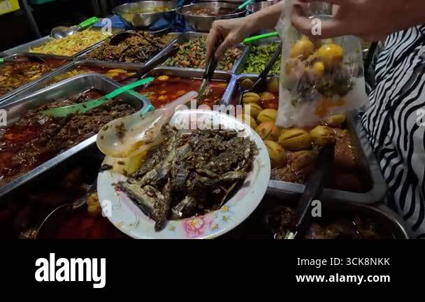 Person serving various dishes at a buffet Stock Video Footage - Alamy