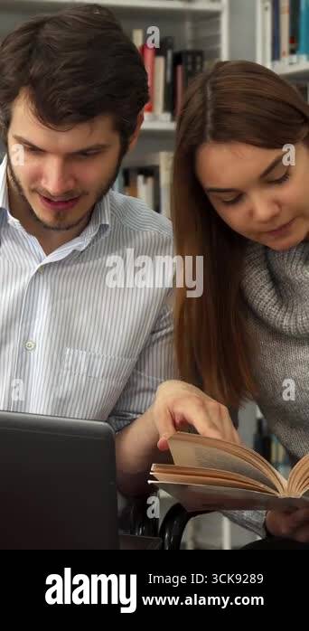 In a cozy library filled with warm light, a beautiful young Caucasian woman eagerly points at ...