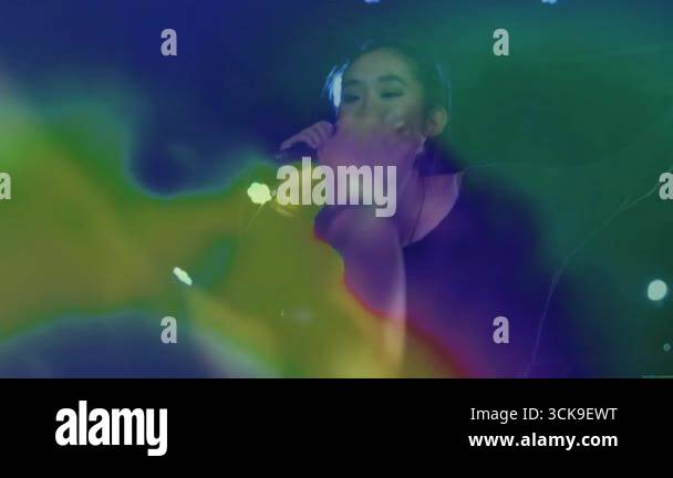 Female singer stepping into spotlight on music stage singing into ...