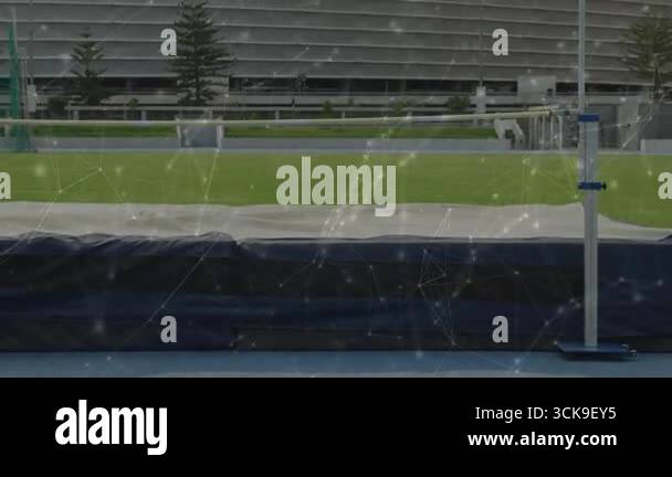 Female athlete sprinting to clear high jump bar in track and field ...