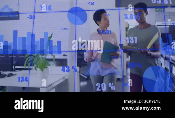 Business professionals walking into frame reviewing reports with ...