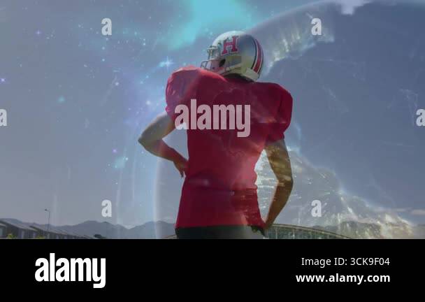 Football player shifting weight and pointing at rotating holographic ...