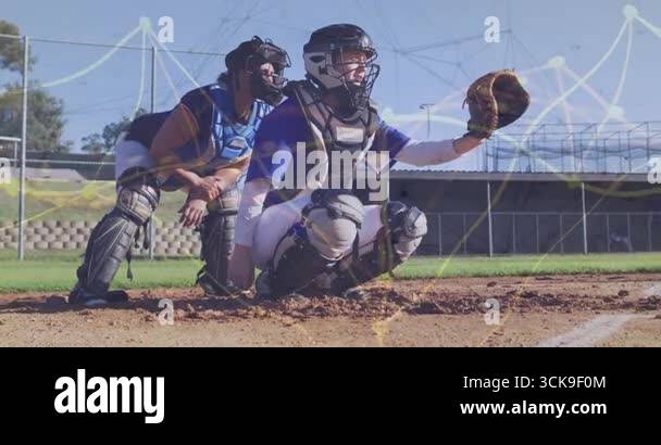 Female catcher crouching at home plate in baseball tracking incoming ...
