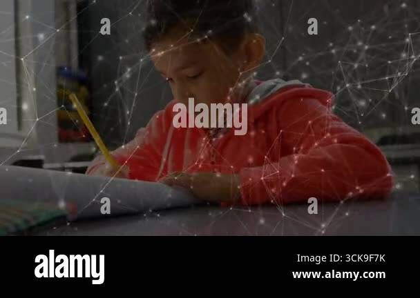 School-age boy starting writing in workbook in classroom, showing digital overlay boosting ...