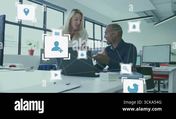 Man typing on laptop, woman leaning discussing as user and play icons fading on business network ...