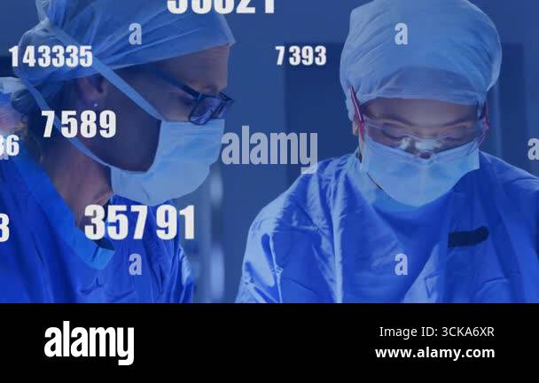 Two surgeons operating in OR and integrating numeric overlays from live ...