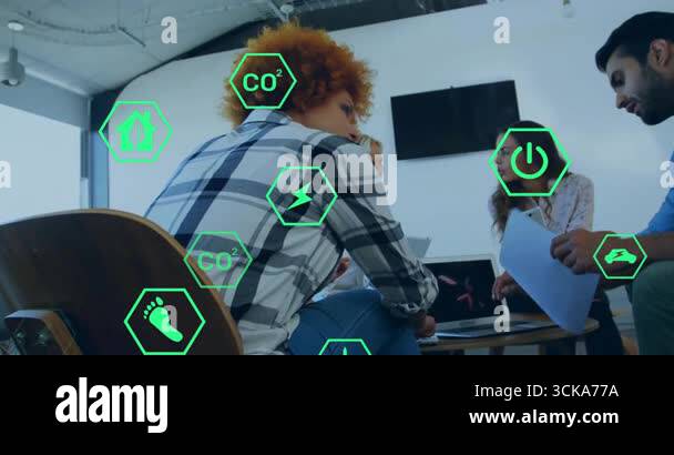 Team gathering around laptop studying environmental data and activating ...