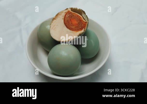 Footage. Salted blue duck eggs are placed on a white bowl. Salted duck ...
