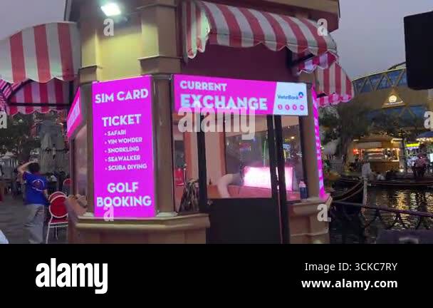 currency exchange office pink sign in the evening illumination at night ...