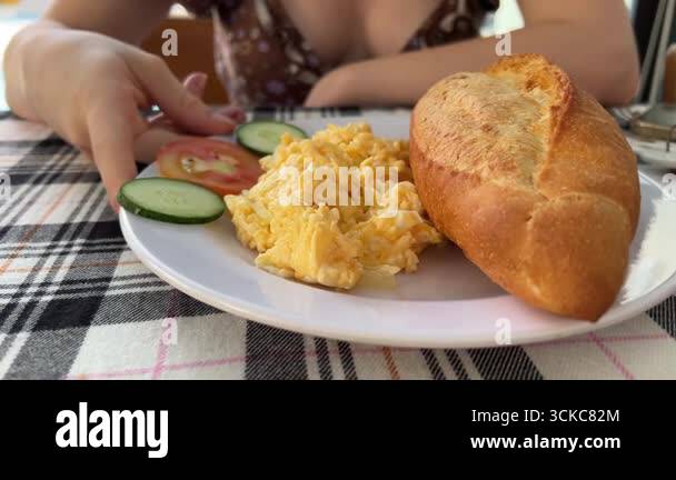 scrambled eggs with bacon and tomato. breakfast on a white plate. food ...