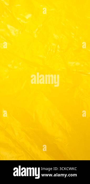 Yellow crumpled plastic bag texture background rotating. Real High ...
