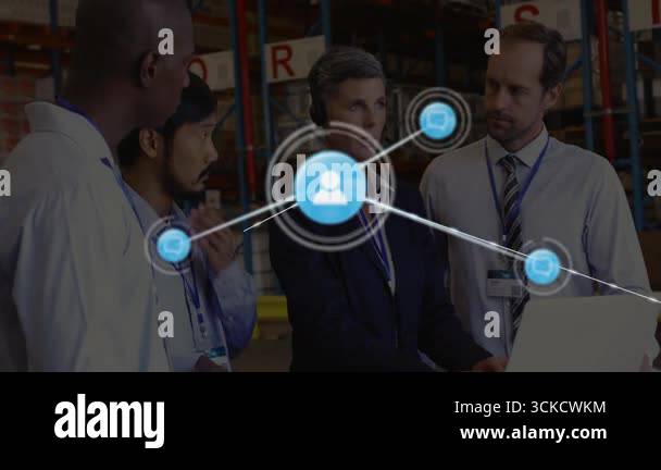 Warehouse team clustering around laptop, initiating node web and ...