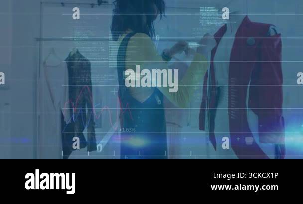 Garment designer surveying rack and measuring red jacket sleeve with ...