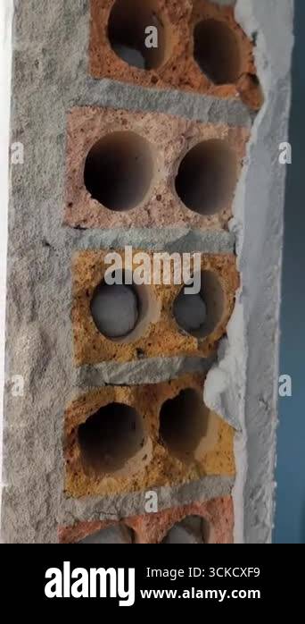 A fragment of an old brick wall, partially covered with plaster. Bricks ...
