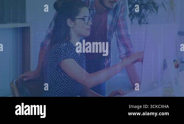 Woman clicking mouse as man leaning over shoulder and guiding chart ...