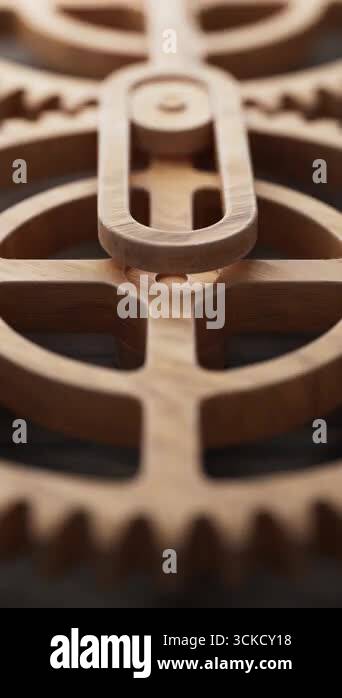Looping animation of two wooden gears connected by a mechanical shaft ...