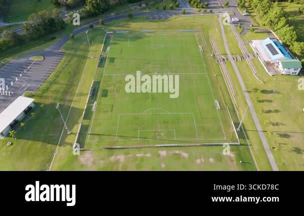 Drone captures a sunny day over a soccer field, highlighting vibrant ...