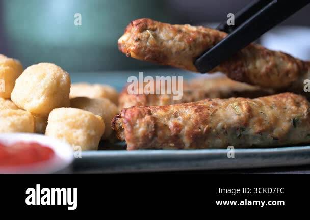 Grilled chicken and beef kebab on a plate with red chilli sauce ...