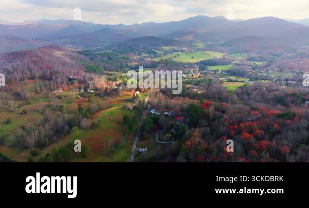 Scattered houses and homesteads in vibrant forest in fall season on ...