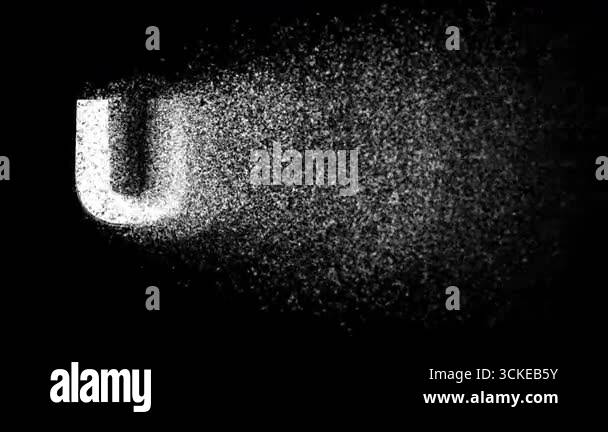 Disappearing English alphabet U into small particles on plain black ...