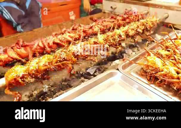 Street vendor grilling quail skewers in Bangkok, showcasing vibrant ...