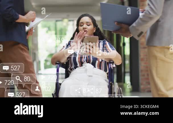 Woman in wheelchair tapping tablet tracking social icons fluctuating ...