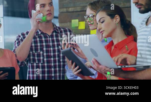 Man lifting smartphone speaking into it and initiating data charts ...