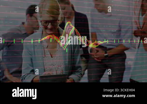 Mature businesswoman tapping tablet as team following moves while ...