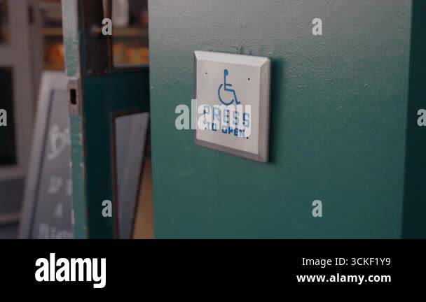 Close-up of an accessibility push button with a wheelchair icon and ...