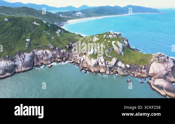 Zoom-out aerial view of the rocky shore of Gravata Beach in ...