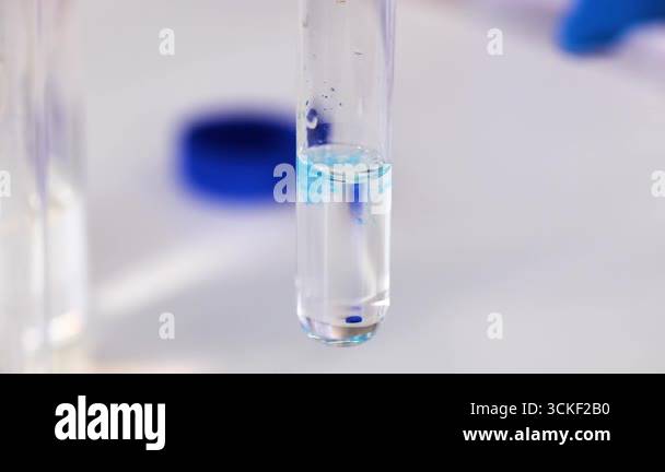 Blue substance reacting in clear liquid solution Stock Video Footage ...