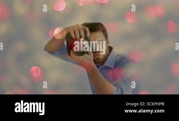 Photographer lifting DSLR camera to eye composing shot with animated ...