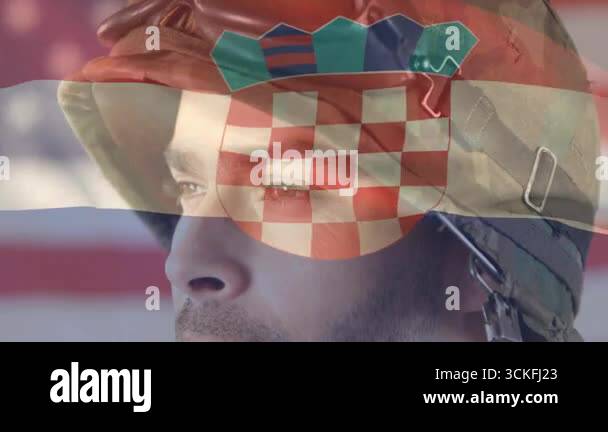 Helmeted soldier turning head at camera showing projected flag with ...