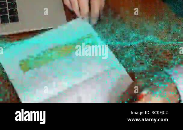 Designer placing notebook and flipping page drawing shapes with ...