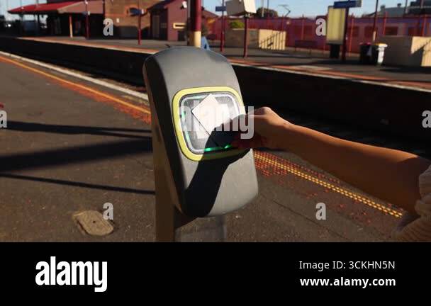 Person tapping card on train station reader Stock Video Footage - Alamy