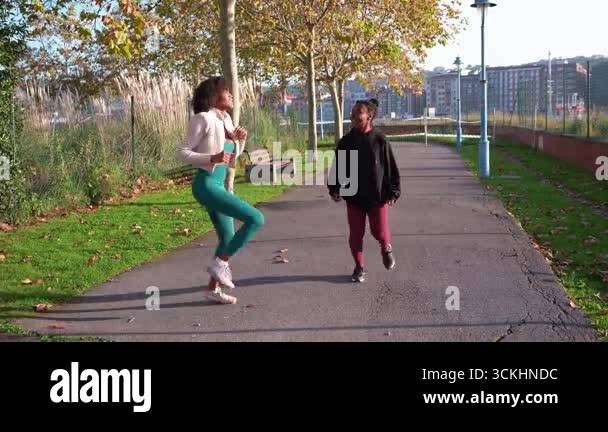 Female athletes synchronizing fitness training, supporting each other ...