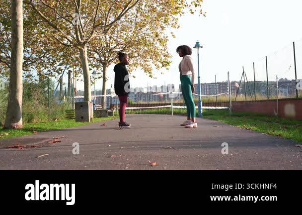 Female athletes synchronizing fitness training, supporting each other ...