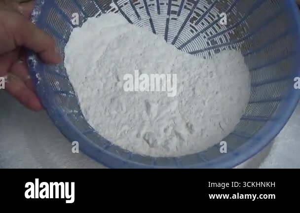 hand of farmer using basket to clean flour Stock Video Footage - Alamy