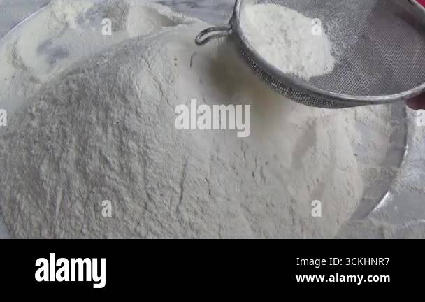 hand of farmer using basket to clean flour Stock Video Footage - Alamy