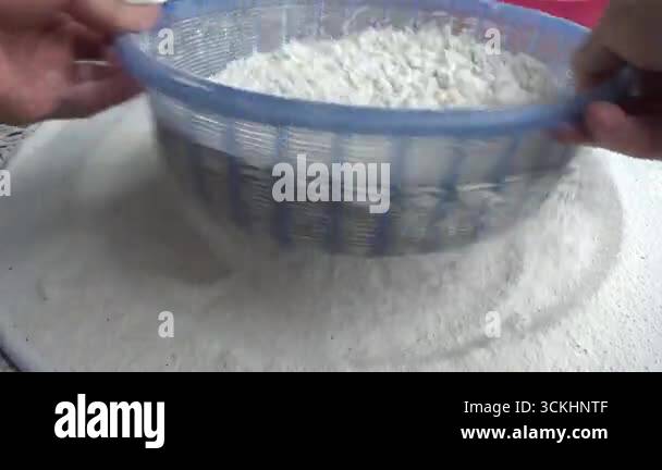 hand of farmer using basket to clean flour Stock Video Footage - Alamy