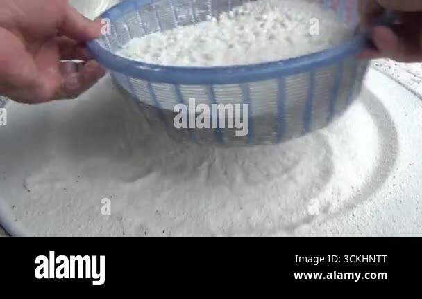 hand of farmer using basket to clean flour Stock Video Footage - Alamy