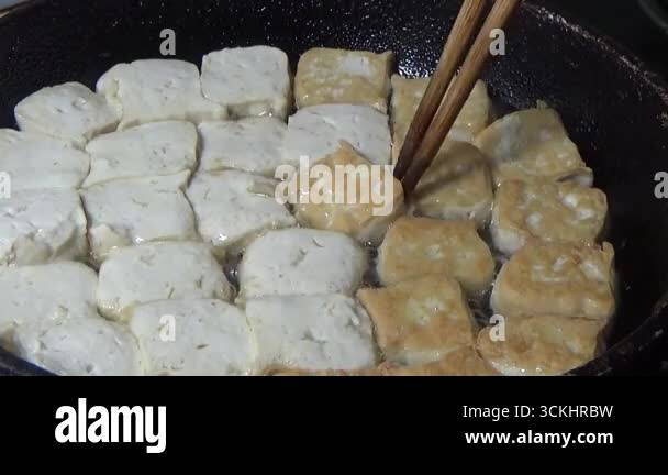 cut and fry the tofu Stock Video Footage - Alamy