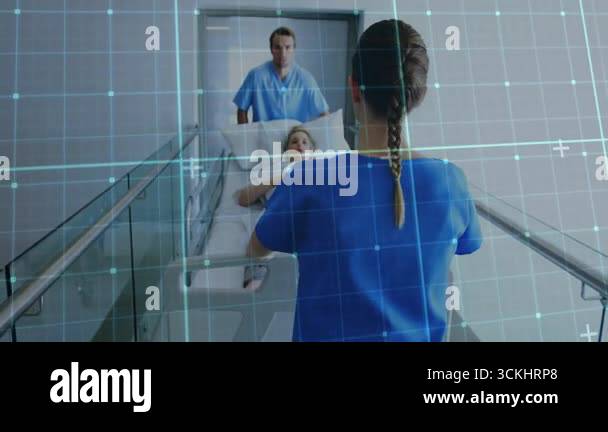 Nurse pushing hospital bed down corridor, forward motion activating grid overlay scanning ...