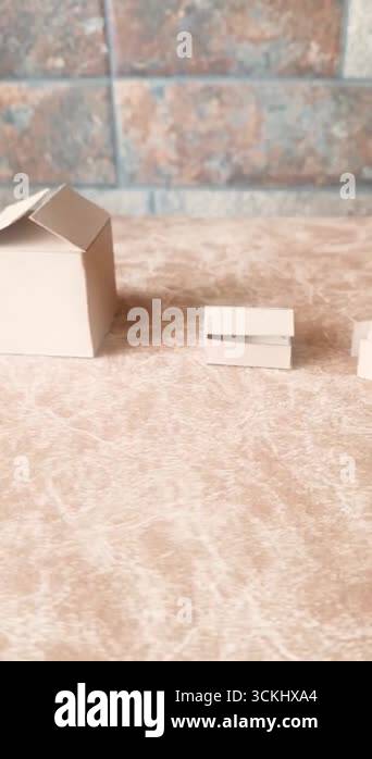 Video panning across several handmade mini cardboard boxes of different ...