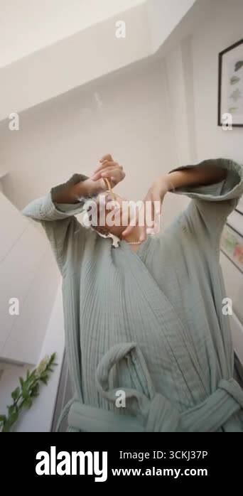 A tranquil indoor scene showcasing a person dressed in a cozy robe ...