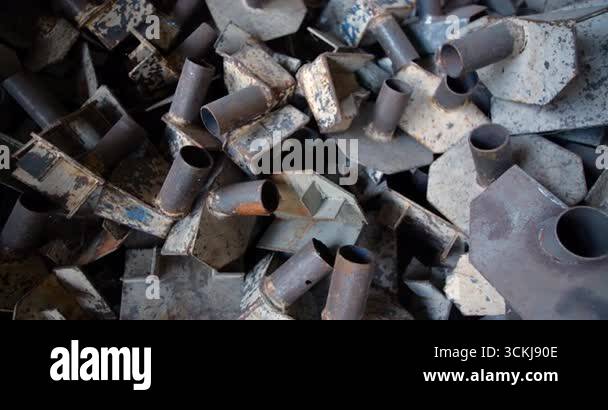 Close-up of a pile of rusty metal parts with signs of wear. A few ...