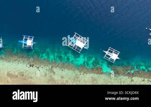 Aerial top-down view of traditional Filipino outrigger boats, locally ...